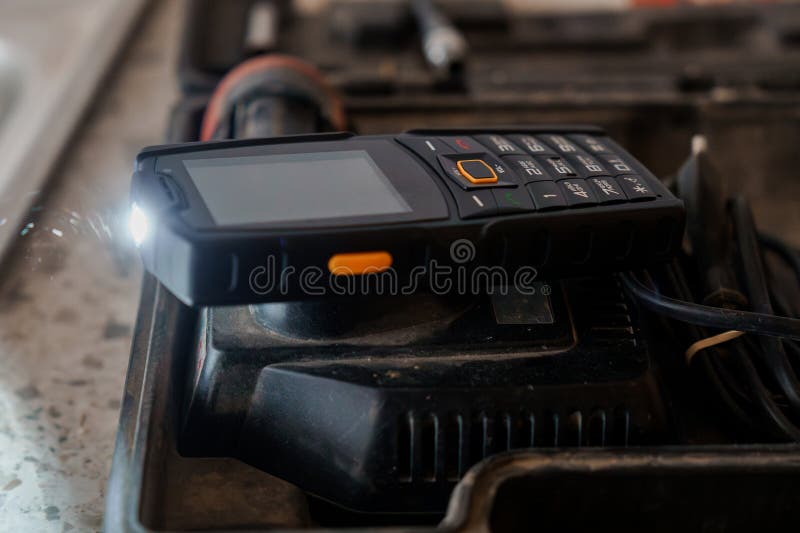 Rugged Mobile Phone with Flashlight on a Tool Box Stock Image - Image ...