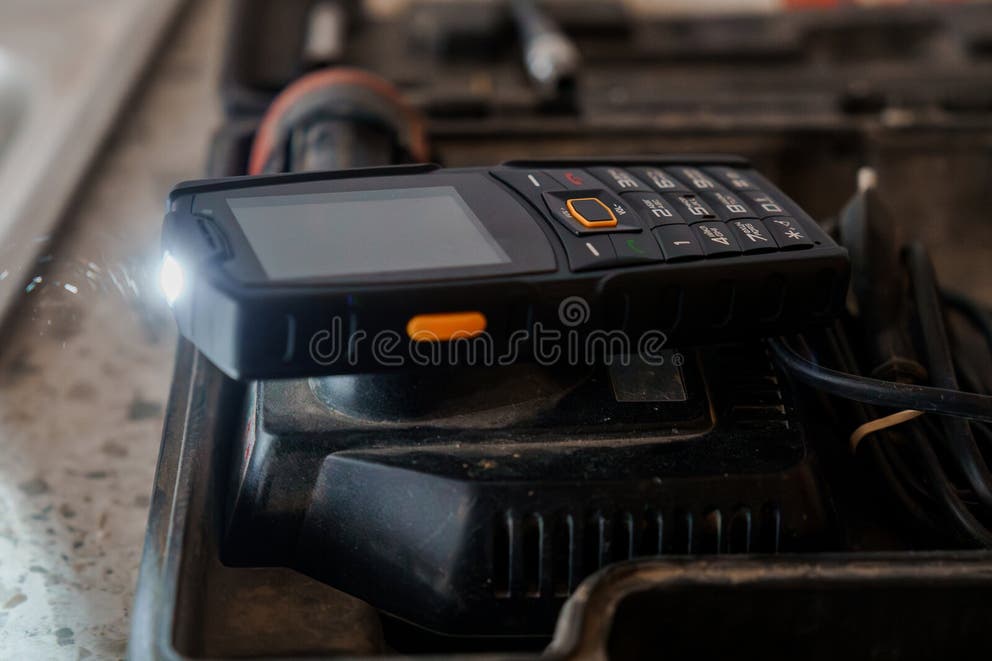 Rugged Mobile Phone with Flashlight on a Tool Box Stock Image - Image ...