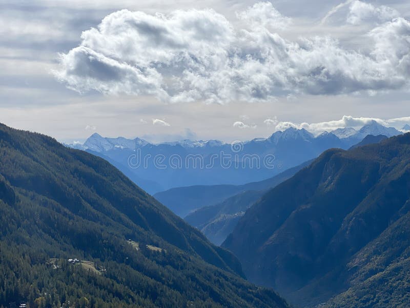 A Rugged Mountain Range with Snow-capped Peaks Rises in the Distance ...