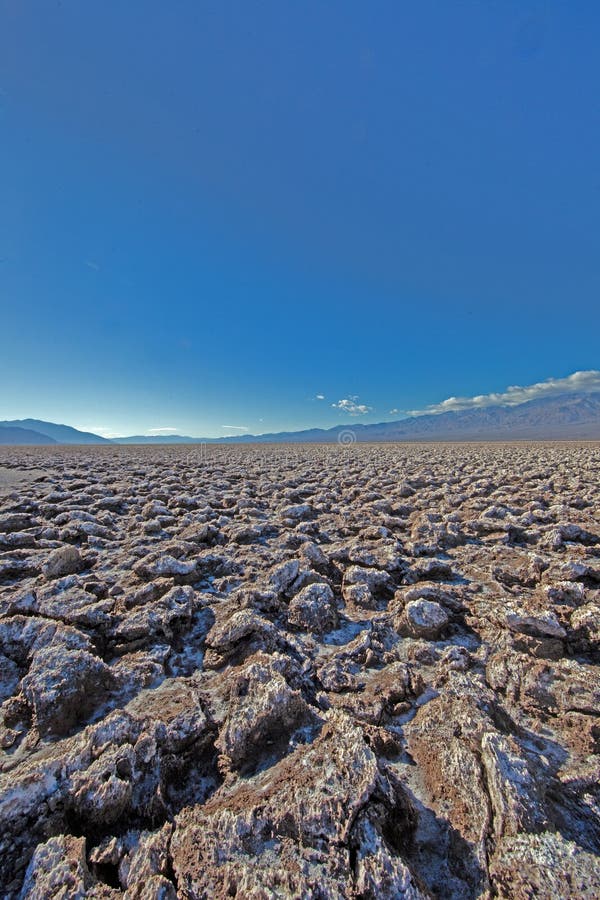 Rugged Salt Formations of Devils Golf Course Under a Bright Blue Sky ...