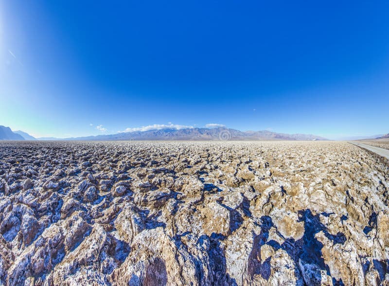 Rugged Salt Formations of Devils Golf Course Under a Bright Blue Sky ...
