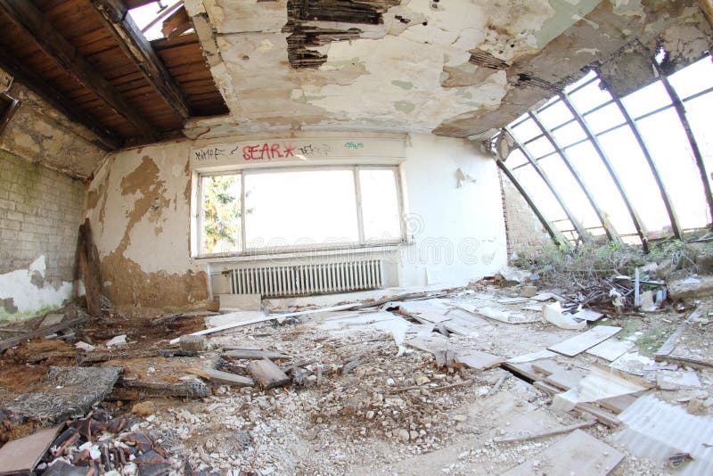 Ruined Room with Holes in Wall, Ceiling and Broken Windows in a Loft ...