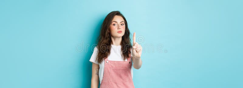 Rule Number One Serious Young Beautiful Girl Shaking Finger In Disapproval Scolding Bad