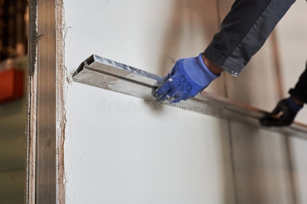 The Rule Tool for Wall Alignment. a Man is Smoothing a Layer of Plaster ...