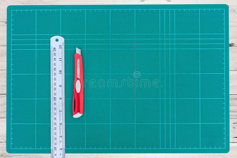 A Ruler and Cutter on Green Cutting Mat Stock Photo - Image of single ...