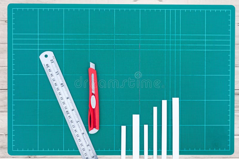 A Ruler and Cutter on Green Cutting Mat Stock Photo - Image of board ...