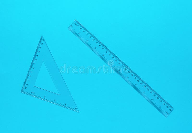 Ruler and Triangle Made of Transparent Plastic on a Blue Background ...
