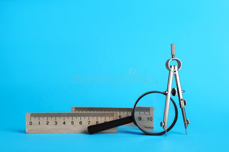 Rulers, Magnifying Glass and Compass on Light Blue Background Stock ...