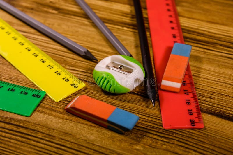 Rulers, Pencils and Erasers on a Wooden Table Stock Image - Image of ...