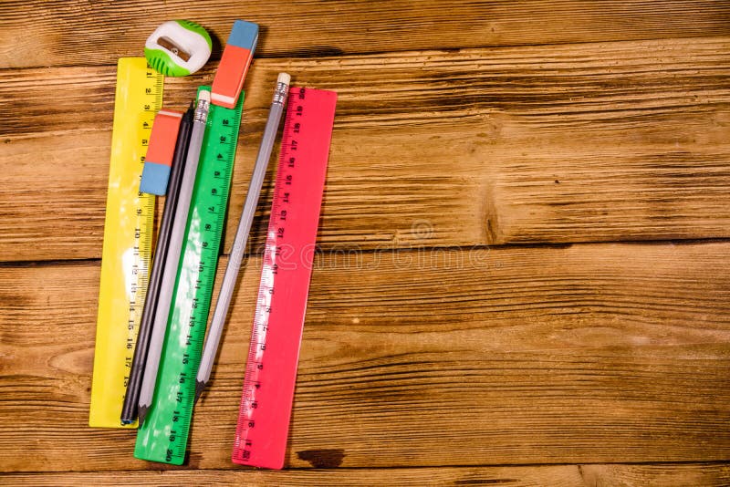 Rulers, Pencils and Erasers on a Wooden Table. Top View Stock Photo ...