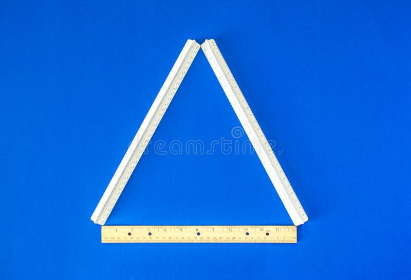 3 Rulers in a Triangle on a Blue Background Stock Photo - Image of ...