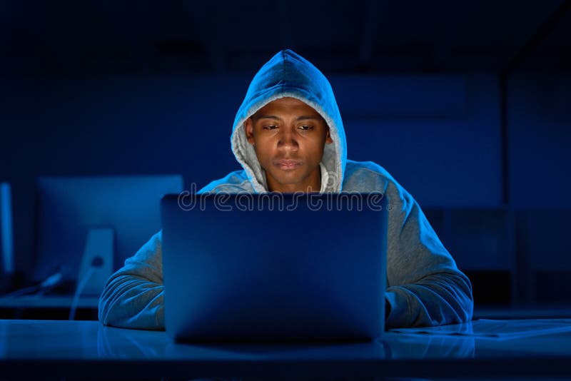 He Rules the Cyber World. a Young Male Hacker Using a Laptop in the ...