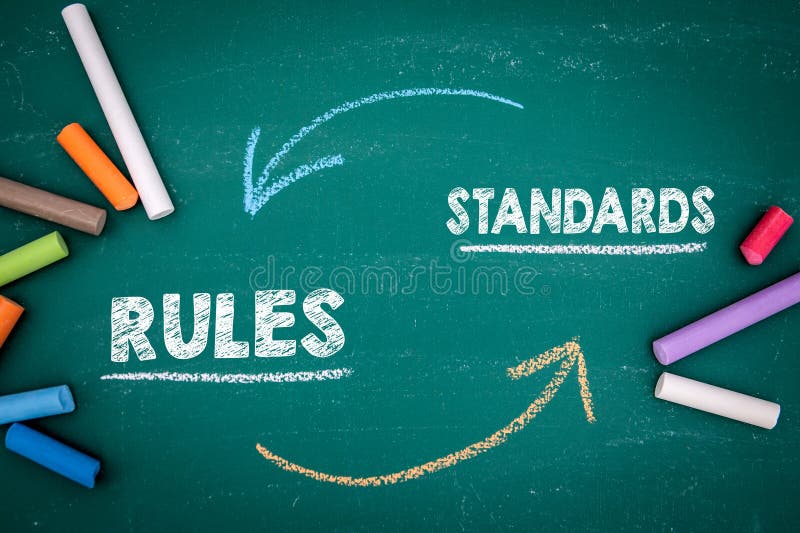 RULES and STANDARDS Concept. Text and Colored Pieces of Chalk on a ...