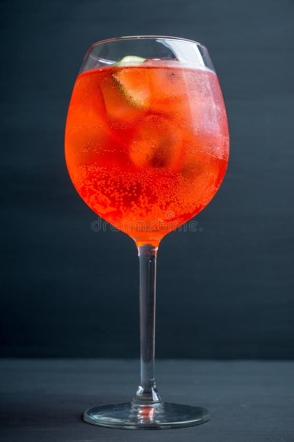 Rum Based Red Cocktail with Lime in Wine Glass Stock Photo - Image of ...