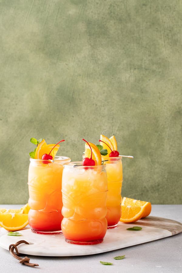 Rum Punch in Tiki Glasses with Orange Slices and a Cherry Stock Image ...