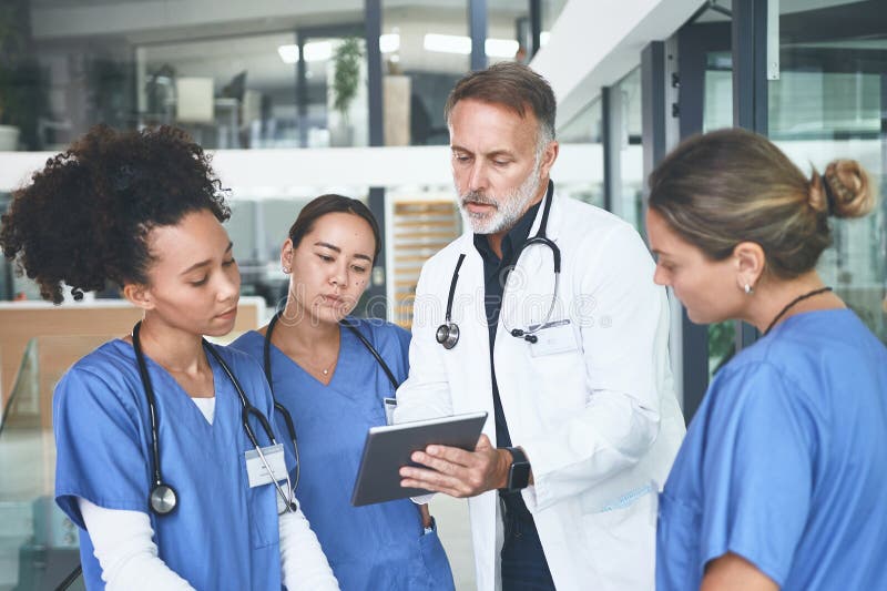 Run Regular Tests on the Patient. a Handsome Mature Doctor Standing ...