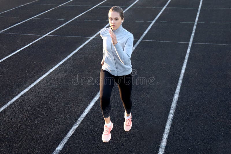 Runner Athlete Running on Athletic Track Training Her Cardio in Stadium ...