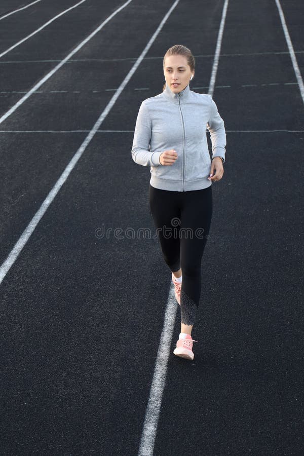 Runner Athlete Running on Athletic Track Training Her Cardio in Stadium ...