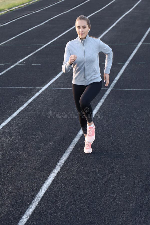 Runner Athlete Running on Athletic Track Training Her Cardio in Stadium ...