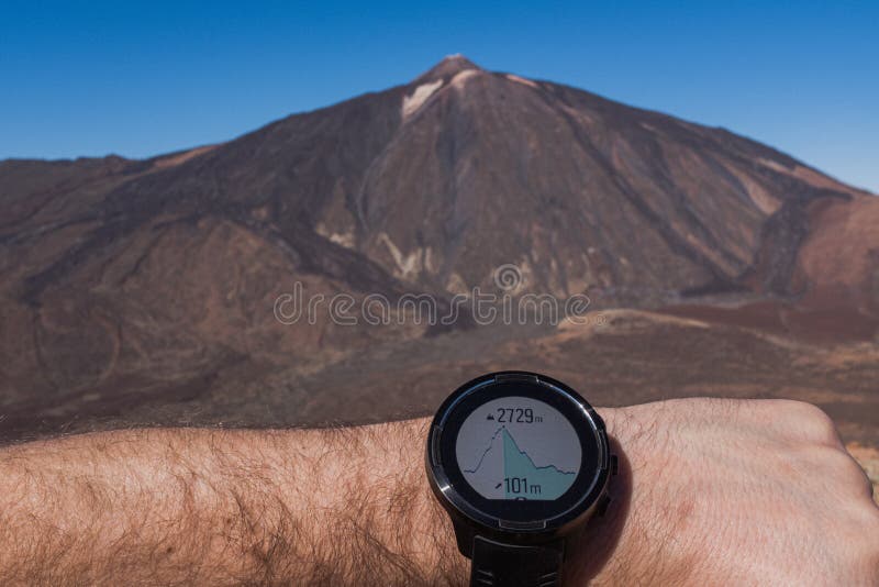 Runner Checking Progress on Smart Watch. Volcano on Background Stock ...