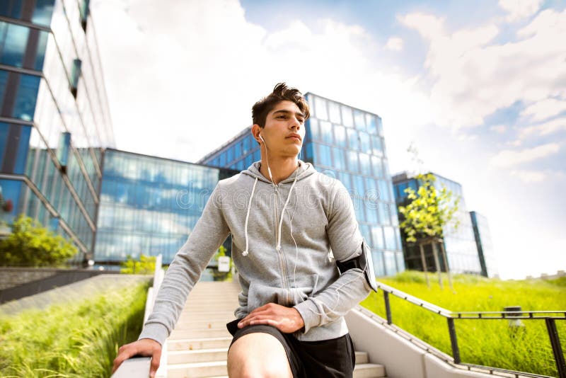 Runner in the City Resting in Front of Glass Buildings. Stock Image ...