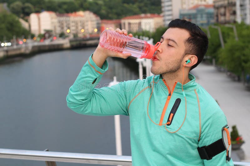 Runner Drinking a Sports Drink Stock Photo - Image of city, adult: 99065666