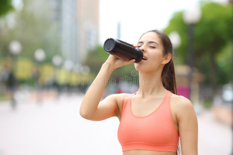 Runner Drinking in the Street Stock Photo - Image of hydrate, outside ...