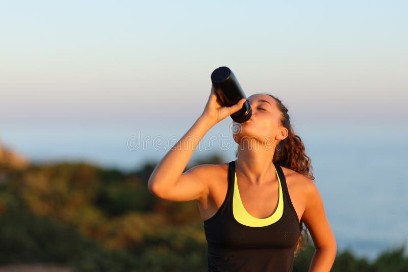 Runner Drinking Water on the Beach Stock Photo - Image of dehydration ...