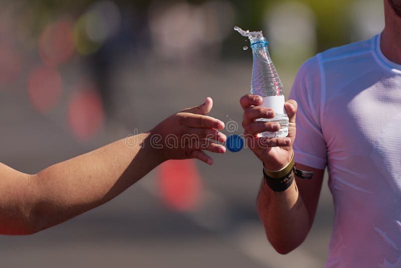 Runner grabbing the water stock photo. Image of fitness - 144822348