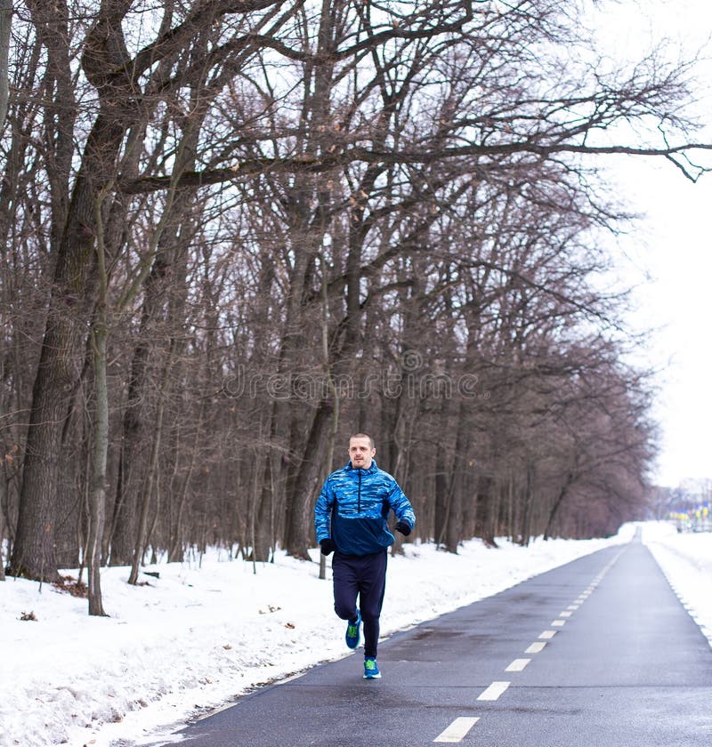 Runner Man in Blue Running Wear Run in Winter Time Stock Image - Image ...
