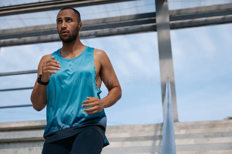 Man in Blue Tshirt Running and Looking Concentrated Stock Image - Image ...