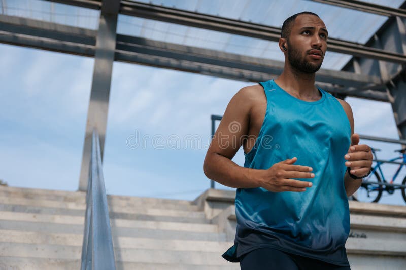 Man in Blue Tshirt Running and Looking Concentrated Stock Image - Image ...