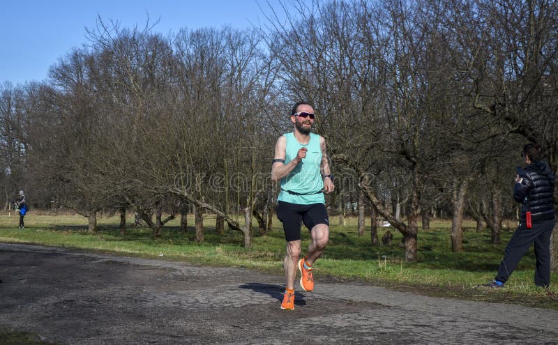 Runner Man Running on Road during Marathon Run Doing High Intensity ...