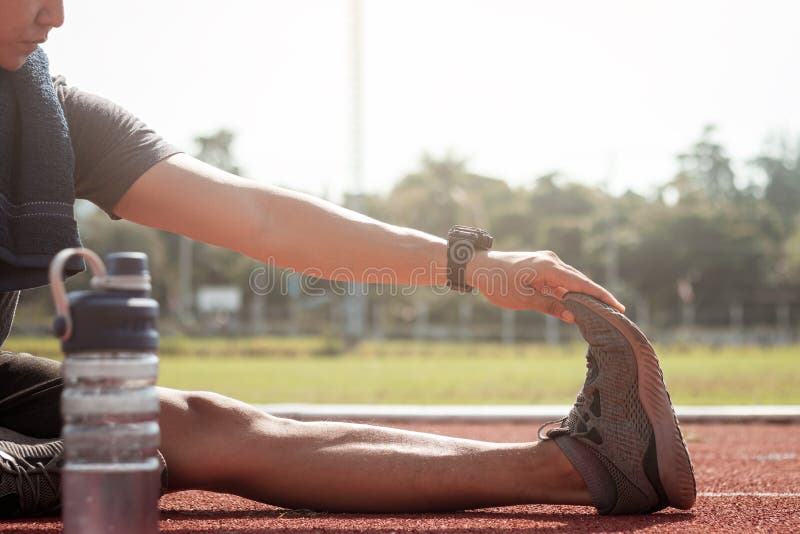 Runner Man is Stretching Legs Preparing for Run Training on Track Stock ...