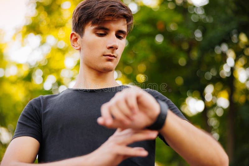 Runner on Mountain Trail Looking at Smartwatch or Sport Watch, Checking ...