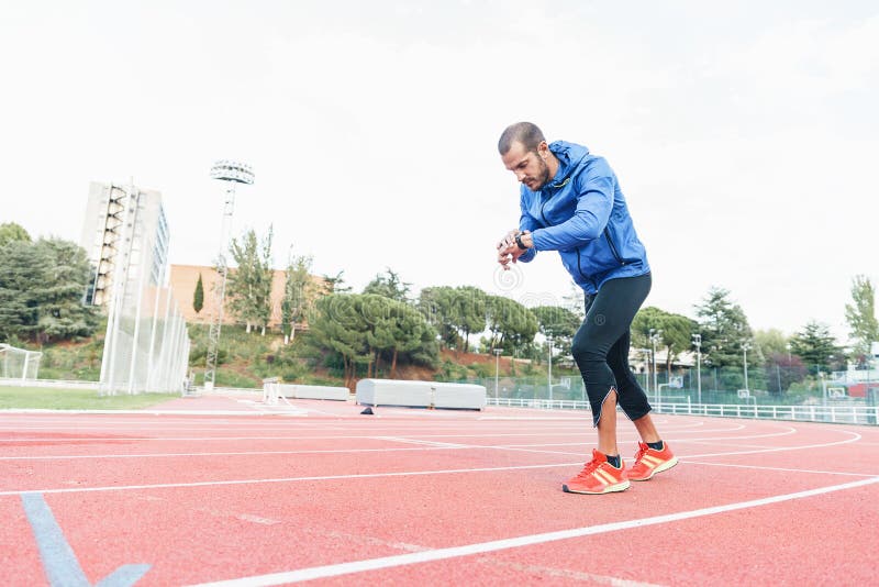 Runner Ready To Run is Looking at His Watch. Stock Image - Image of ...