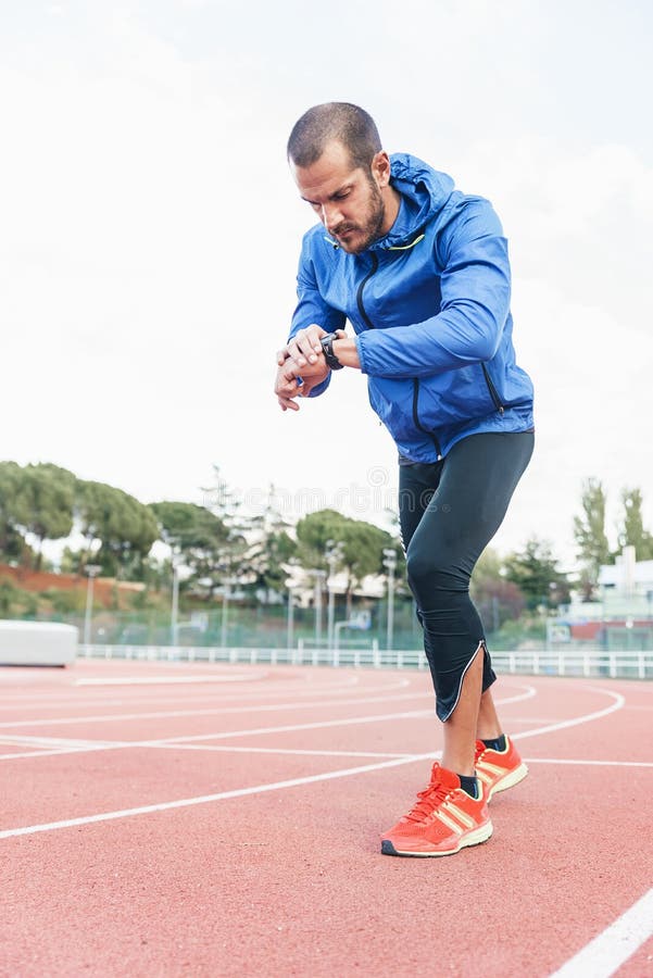 Runner Ready To Run is Looking at His Watch. Stock Image - Image of ...