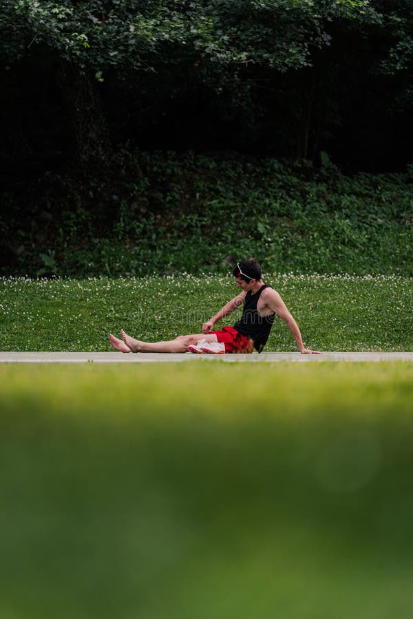 Runner Sitting on the Ground after a Hard and Intense Training Session ...