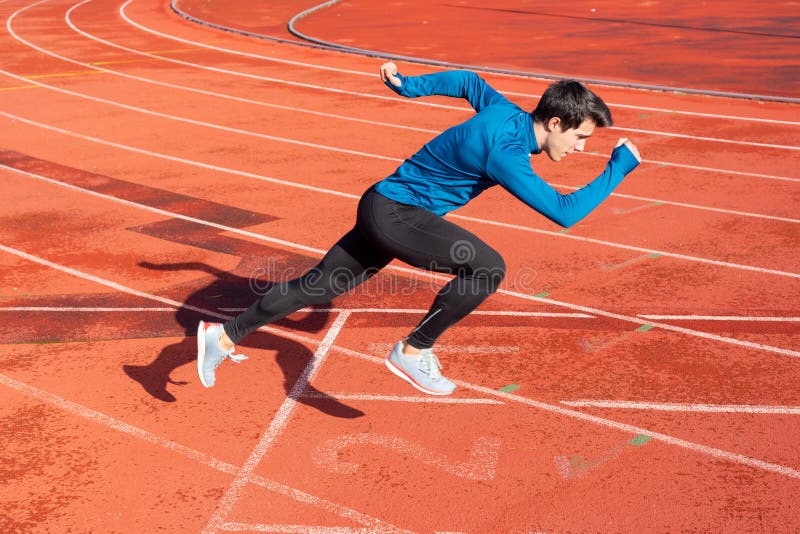 Man Athlete on the Starting Line of a Running Track at the Stadium ...