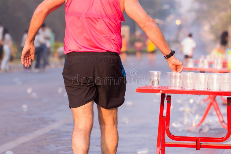 Runner Take a Water in a Marathon Race Editorial Stock Image - Image of ...