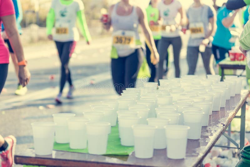 Runner Taking a Cup of Water at H20 Stand. Stock Image - Image of road ...