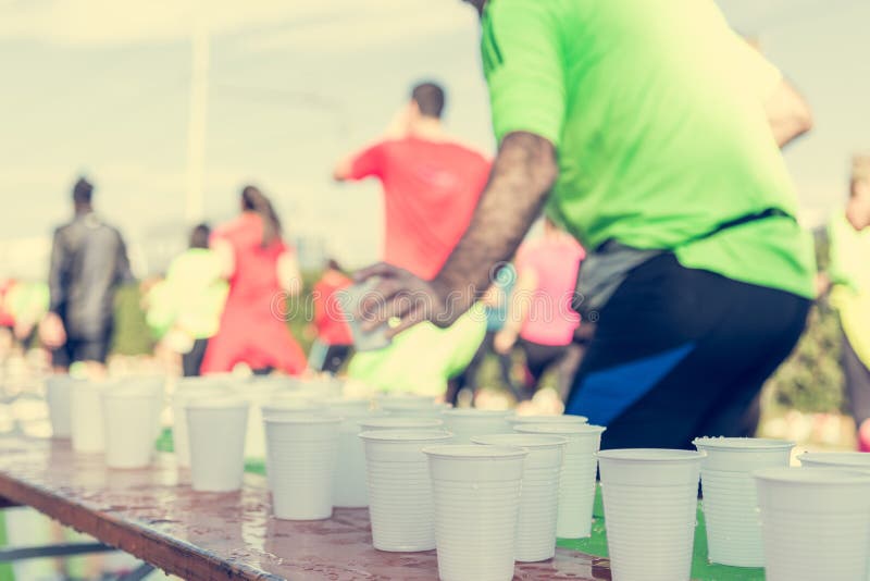 Runner Taking a Cup of Water at H20 Stand. Stock Image - Image of ...