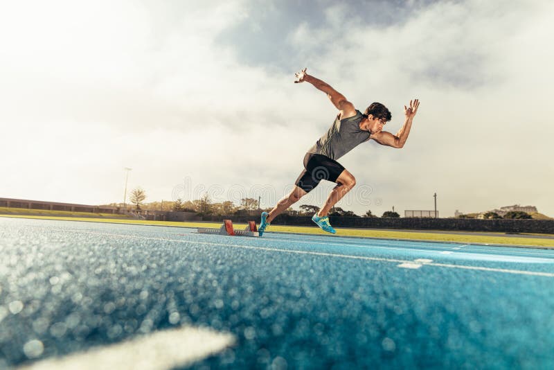 Sprinter Taking Off from Starting Block on Running Track Stock Photo ...