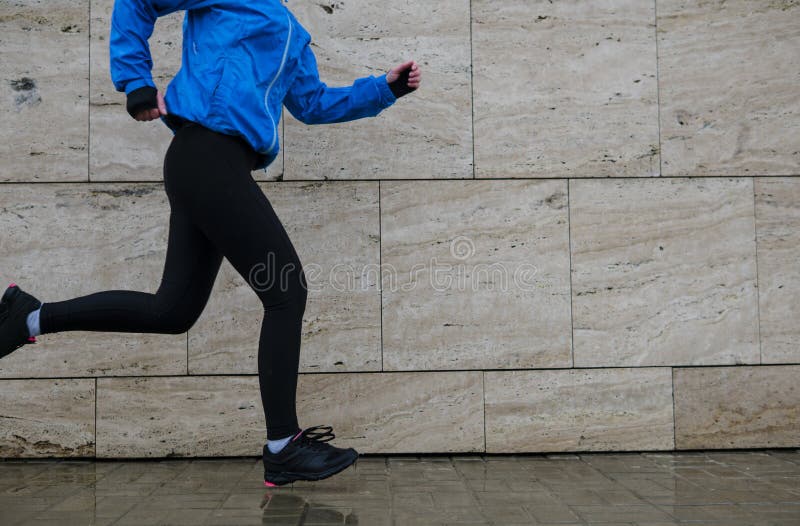 Runner Woman Running in City in the Rain. Jogging Training for M Stock ...