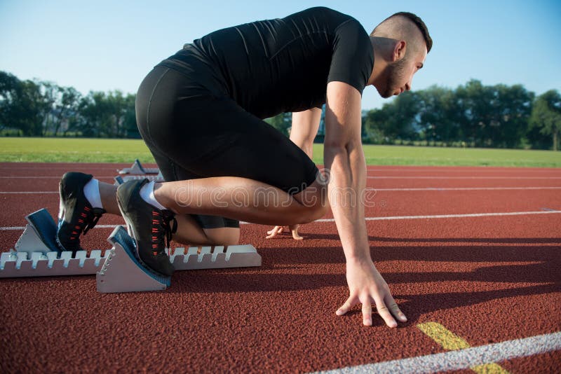 Runners Preparing for Race at Starting Blocks Stock Photo - Image of ...