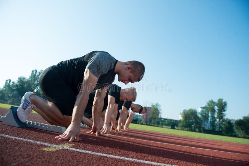 Runners Preparing for Race at Starting Blocks Stock Image - Image of ...