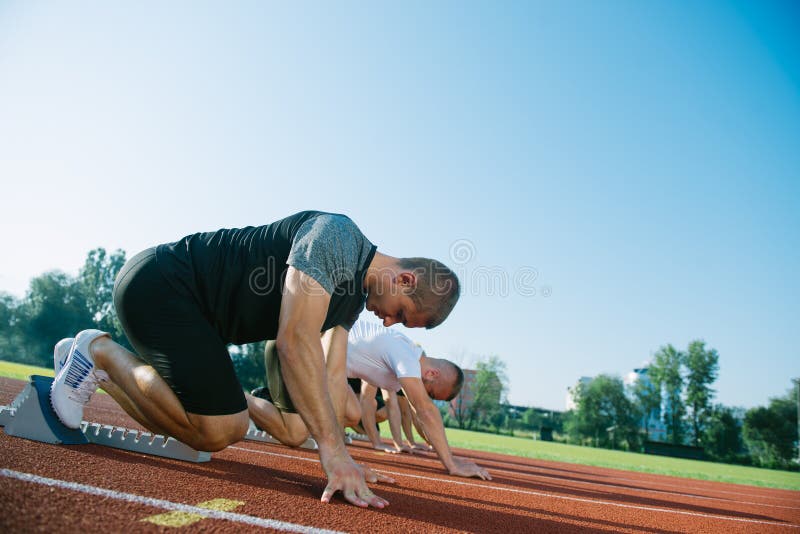 Runners Preparing for Race at Starting Blocks Stock Photo - Image of ...