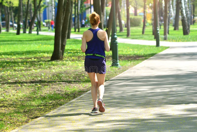 Running. Active Woman Runs Cross in the Summer Park. Editorial Stock ...