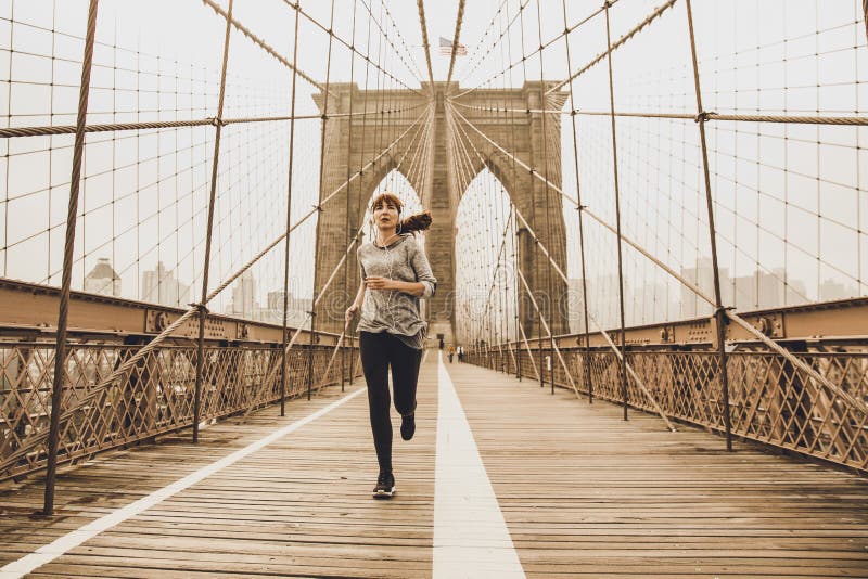 Running on Brooklyn bridge stock image. Image of girl - 218797047