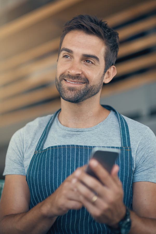 Running a Coffee Shop with Smart Apps. a Young Man Using a Mobile Phone ...
